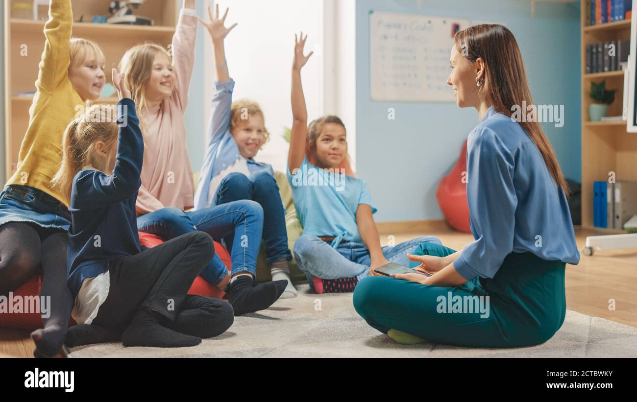 Elementary School Creativity Class: Children Sitting on the Bean Bags ...
