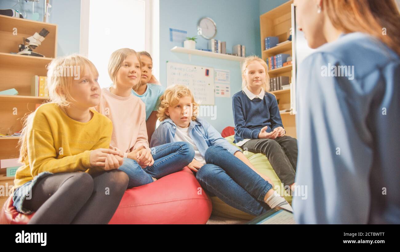 Elementary School Creativity Class: Children Sitting on the Carpet ...