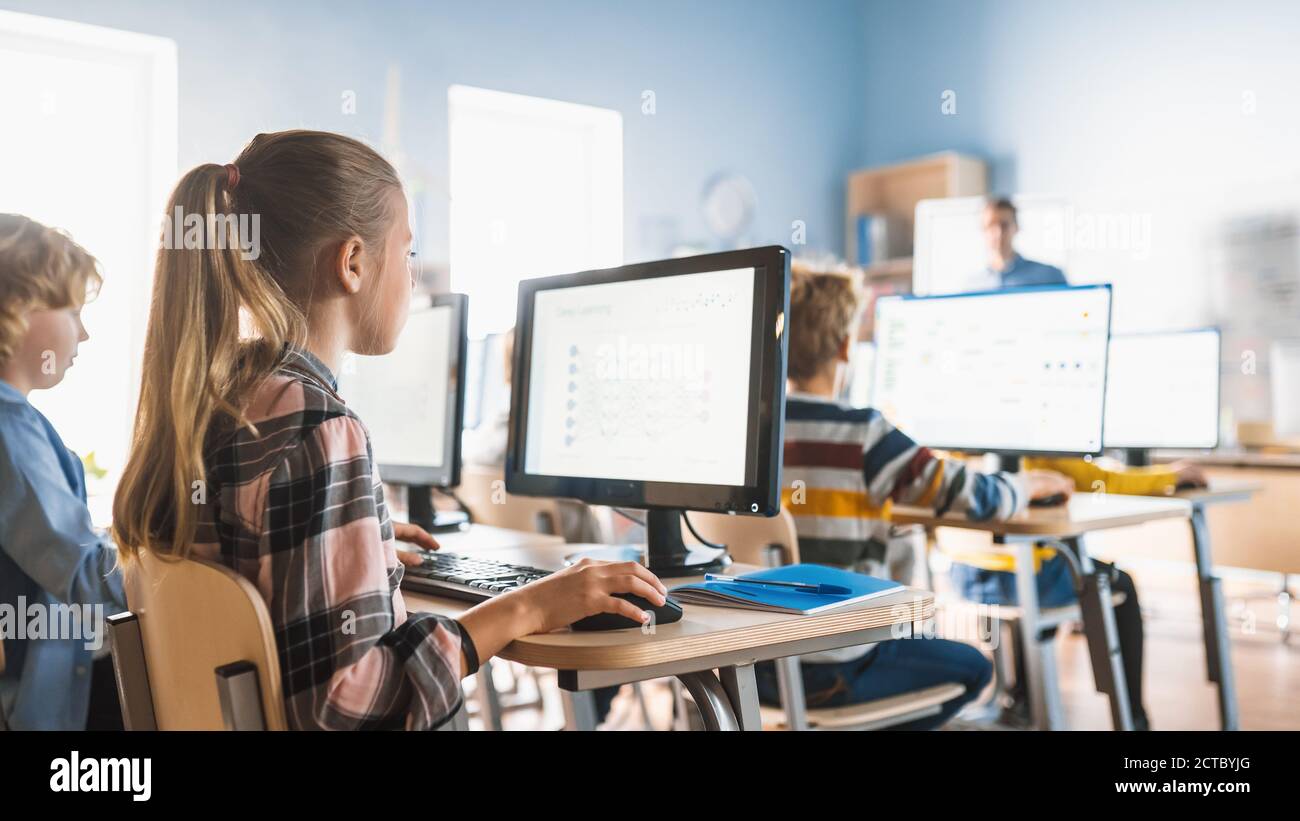 Elementary School Computer Science Classroom: Cute Little Girl Uses ...