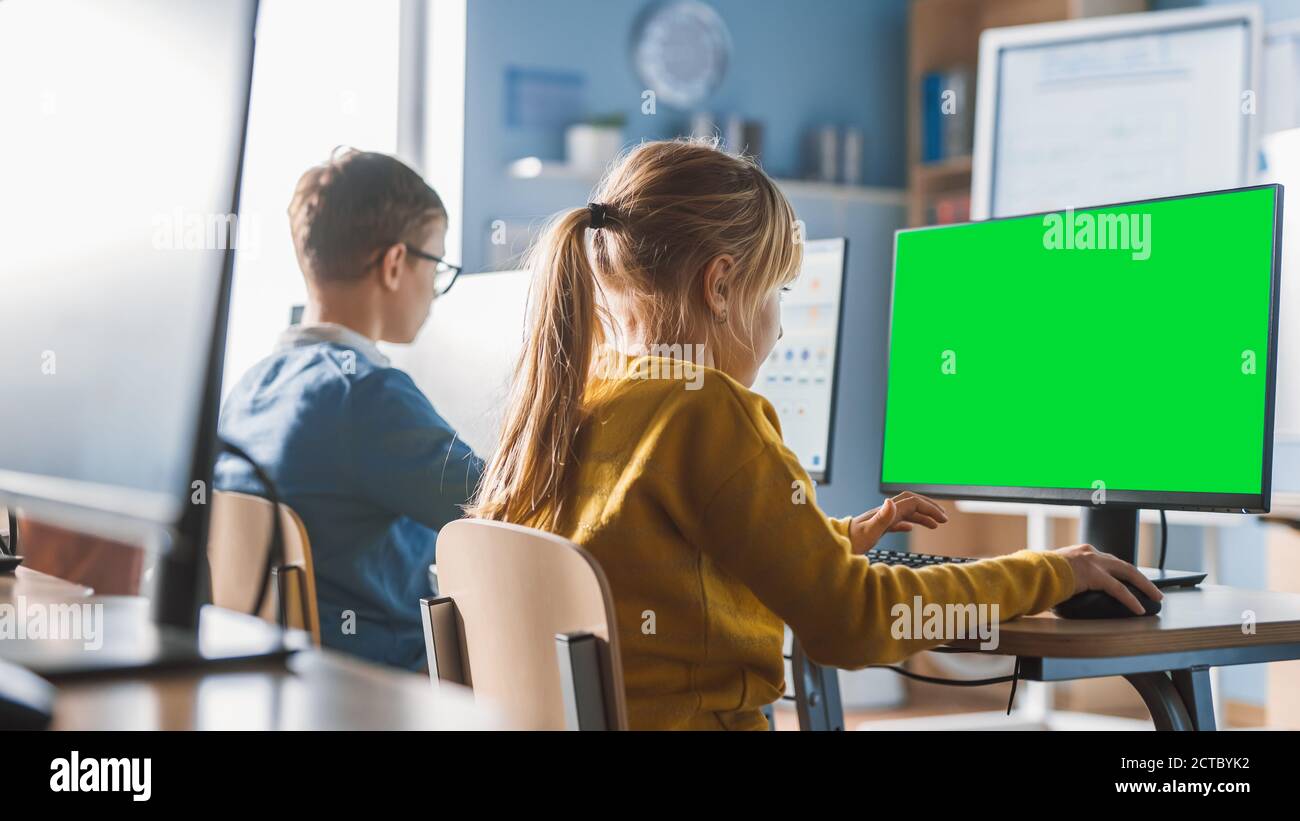 Elementary School Computer Science Classroom: Cute Little Girl Uses ...