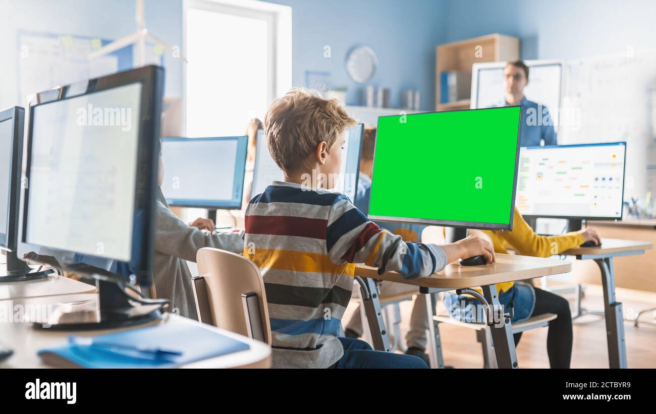 Elementary School Computer Science Classroom: Cute Little Boy Uses ...