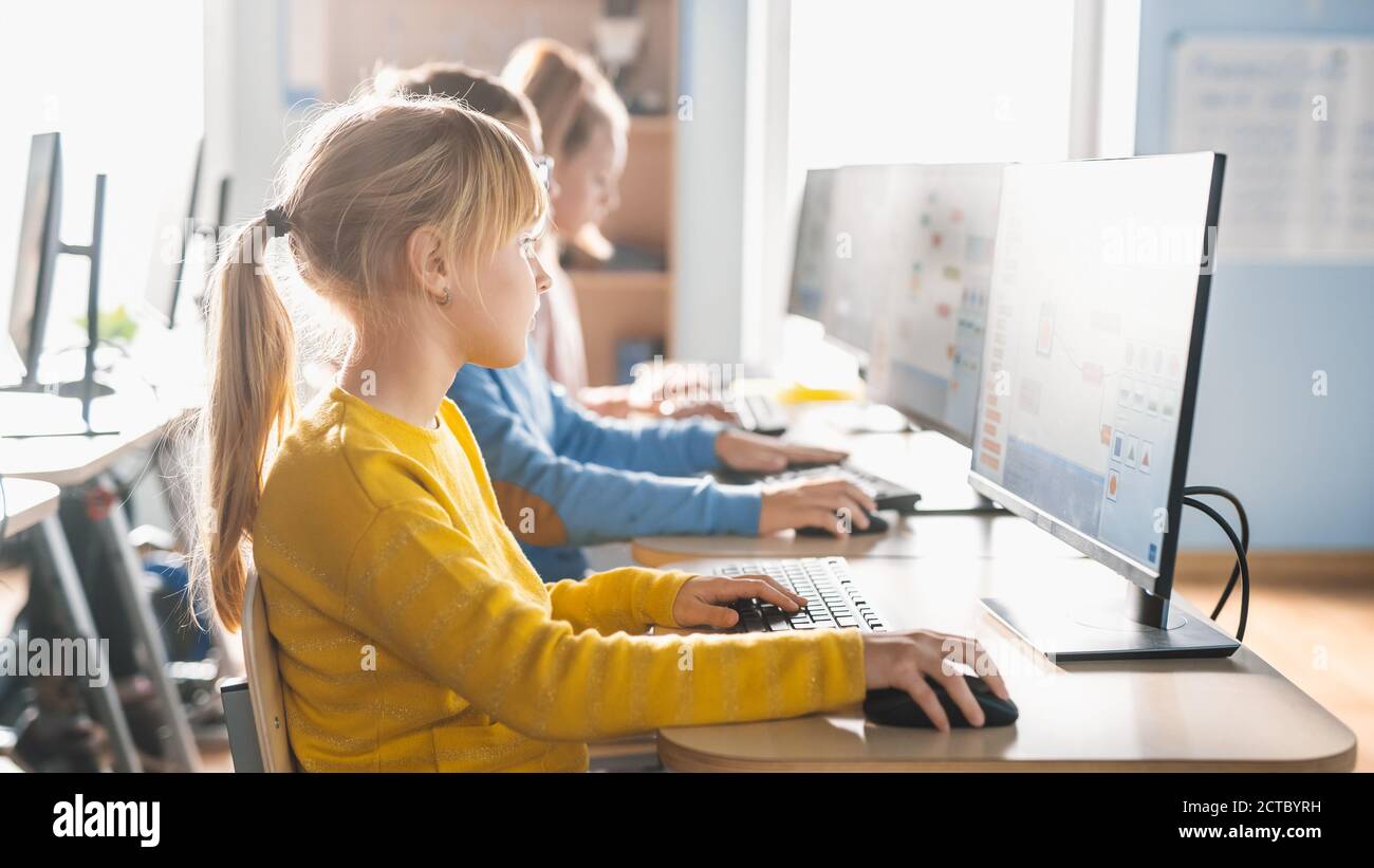 Elementary School Computer Science Classroom: Cute Little Girl Uses ...