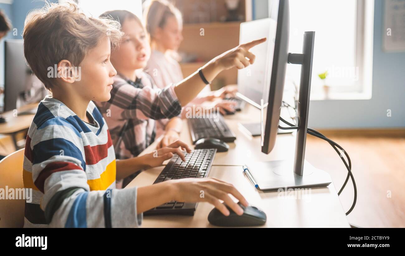 Elementary School Computer Science Classroom: Smart Girl Helps Boy ...