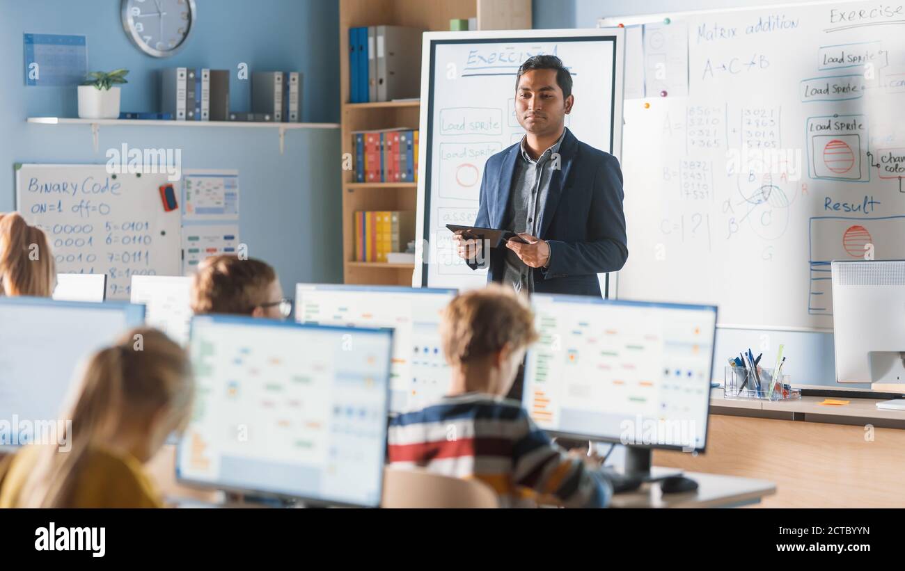Elementary School Computer Science Class: Teacher Uses Digital Tablet ...