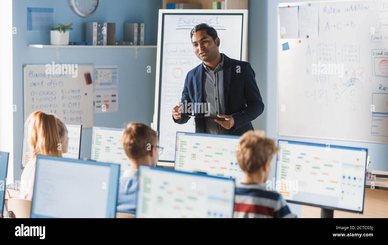 Elementary School Computer Science Class: Teacher Uses Digital Tablet ...