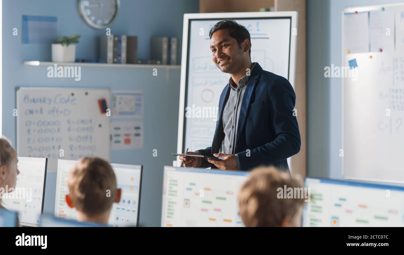 Elementary School Computer Science Class: Teacher Uses Digital Tablet ...