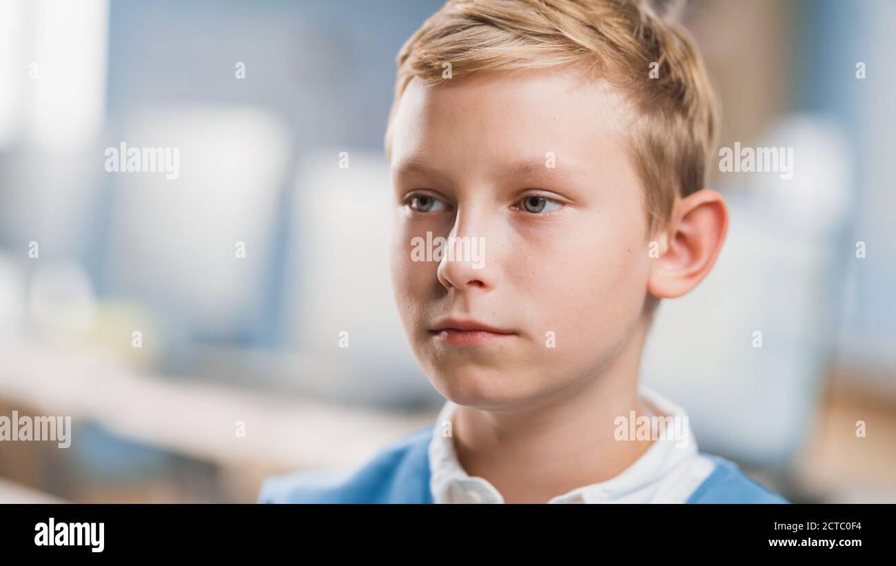 Portrait of a Serious and Concentrated Little Boy Sitting at his School ...