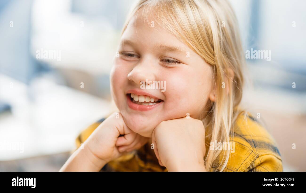 Portrait of a Cute Little Girl with Blond Hair Sitting at her School ...