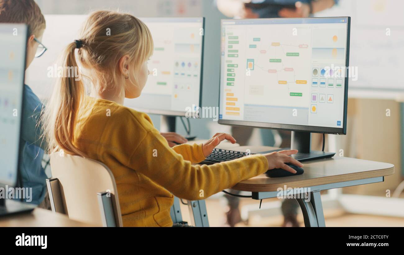 Elementary School Computer Science Classroom: Cute Little Girl Uses ...