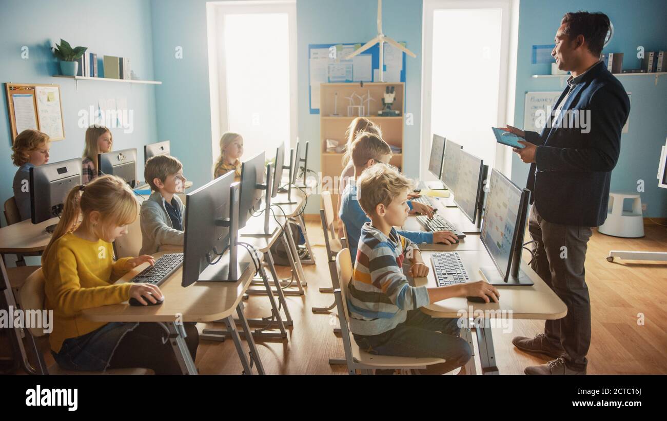 Elementary School Computer Science Classroom: Teacher Uses Tablet ...