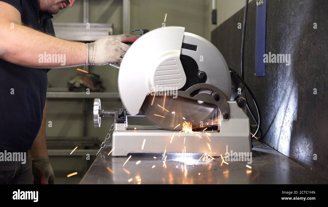 Iron sawing close up. Hot sparks at grinding metal Stock Photo - Alamy