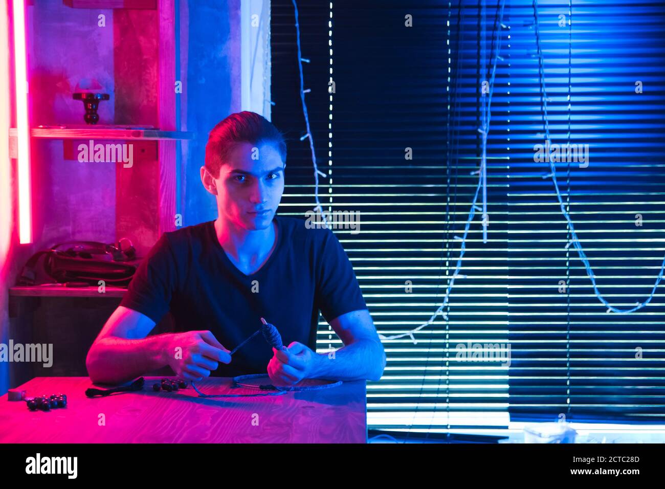 Artisan makes new dreamcatcher in art studio. Master in dark workshop ...