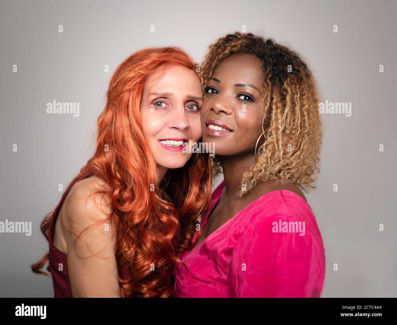 Horizontal portrait of two elegant and beautiful black and white women ...