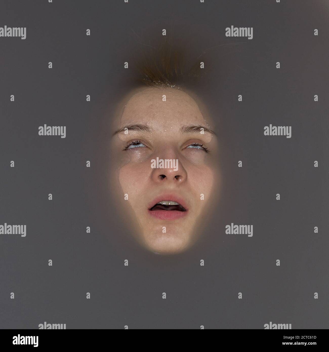 Closeup shot of a disturbing face of a female deep in gray water Stock ...