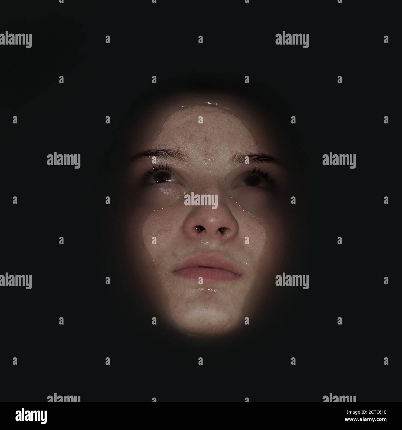 Closeup shot of a disturbing face of a female deep in gray water Stock ...