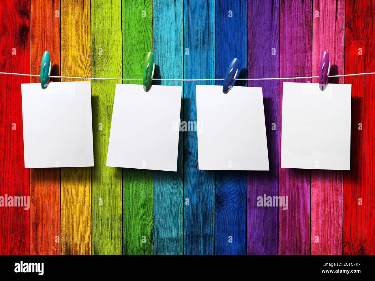 Clothespin hanging with photo papers on colourful wooden fence Stock ...