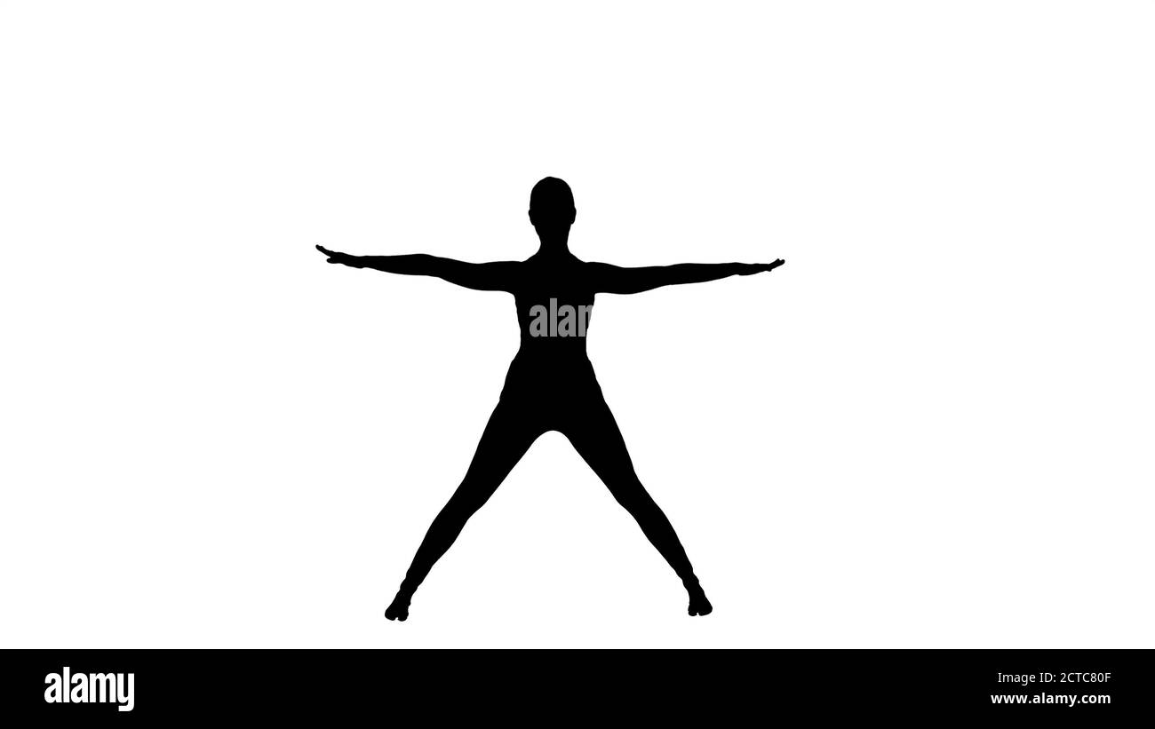 Silhouette Young woman in forward bending asana yoga pose Stock Photo ...