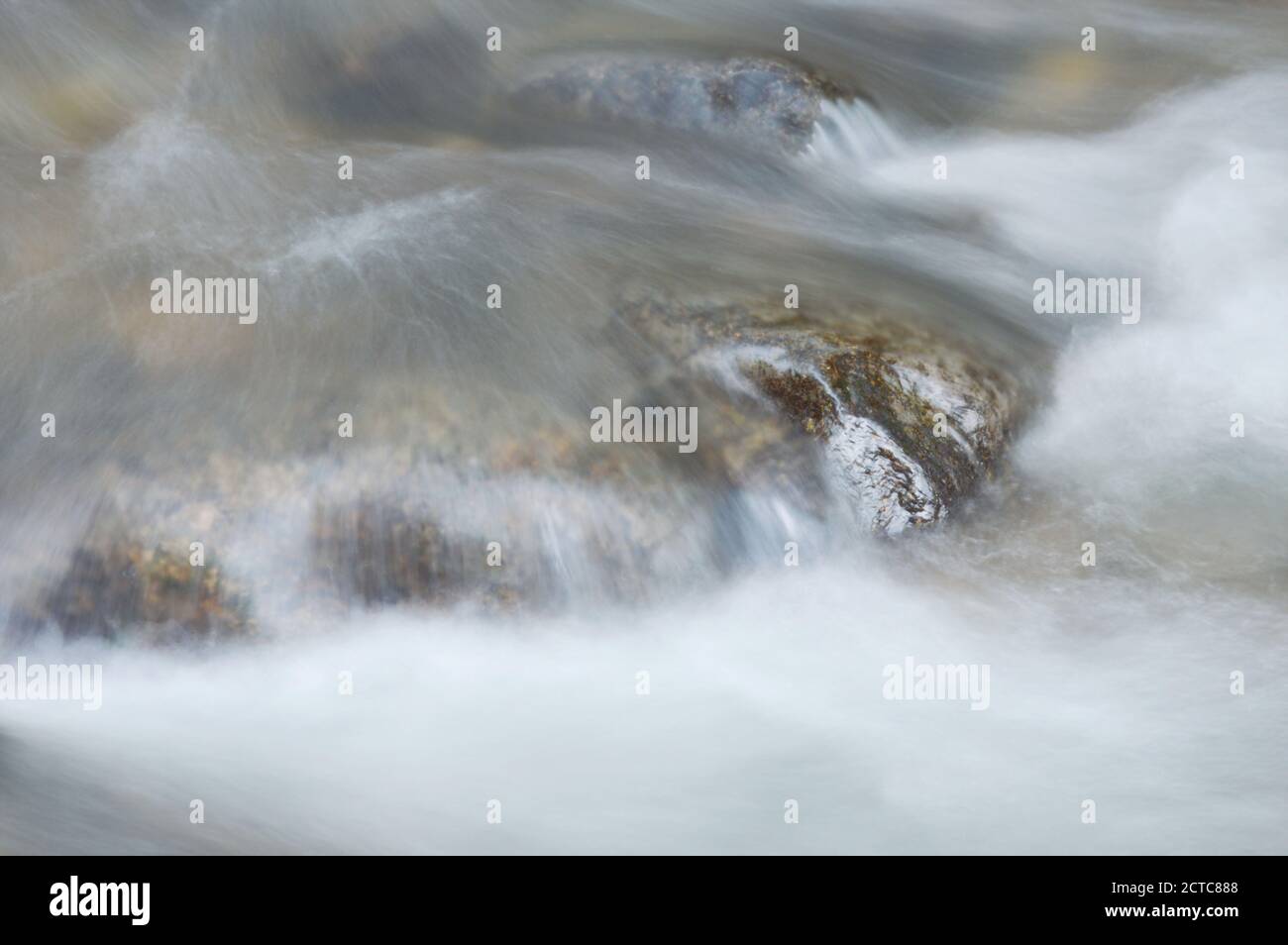 Blurry water flowing on the rock and wave splashing in river Stock ...