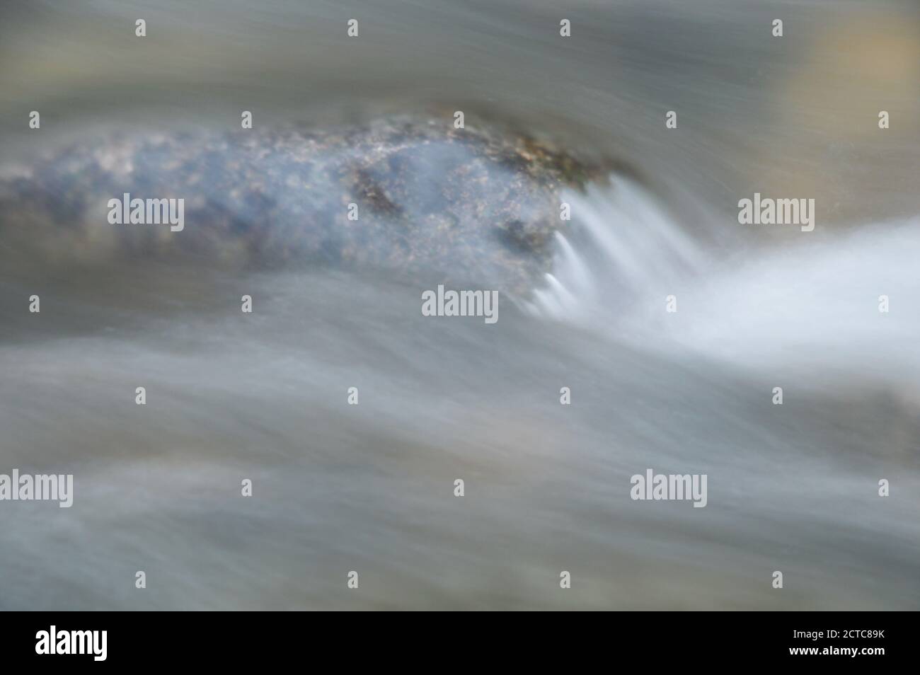 Blurry water flowing on the rock and wave splashing in river Stock ...