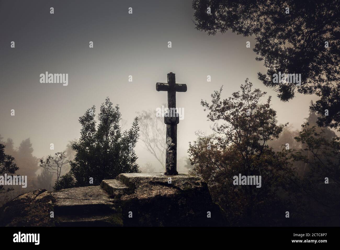 Shot of a beautiful religious stone cross on a foggy day Stock Photo ...