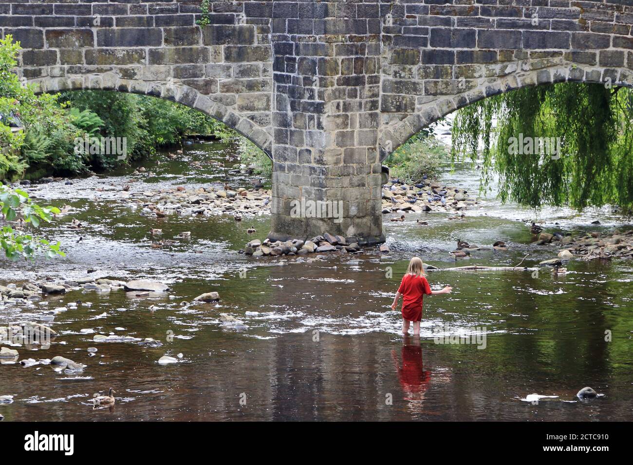 Young girl playing in Hebden Water Stock Photo - Alamy