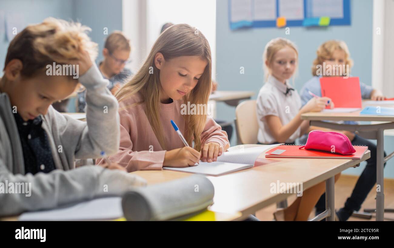 Elementary Classroom of Diverse Children Listening Attentively to their ...