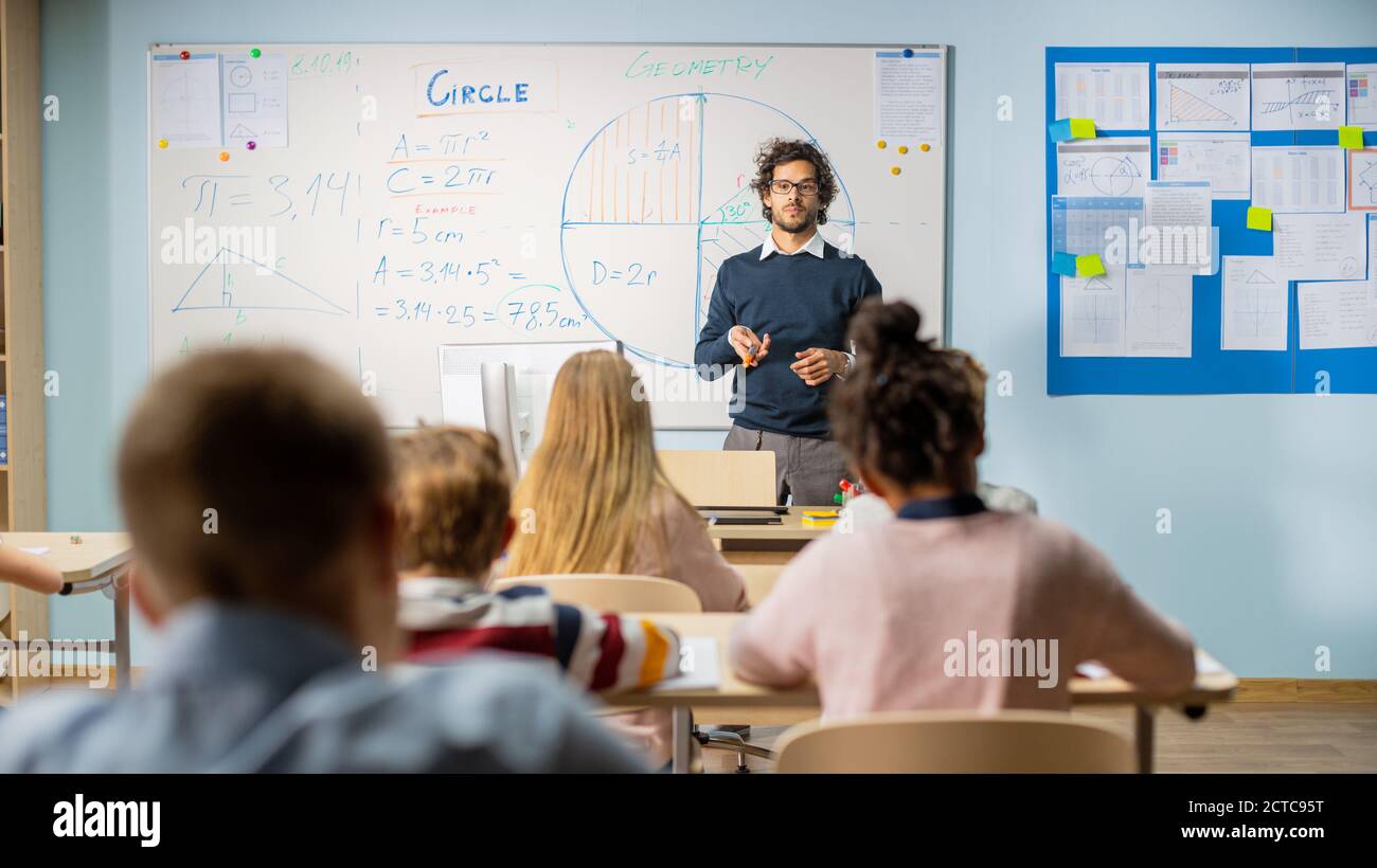 Shot of Teacher Explaining Lesson to Classroom Full of Diverse Bright ...