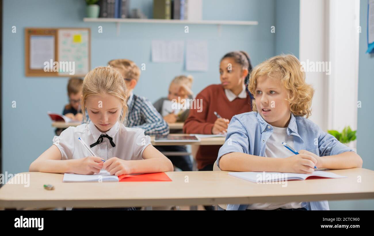 Elementary Classroom of Diverse Bright Children Listening Attentively ...