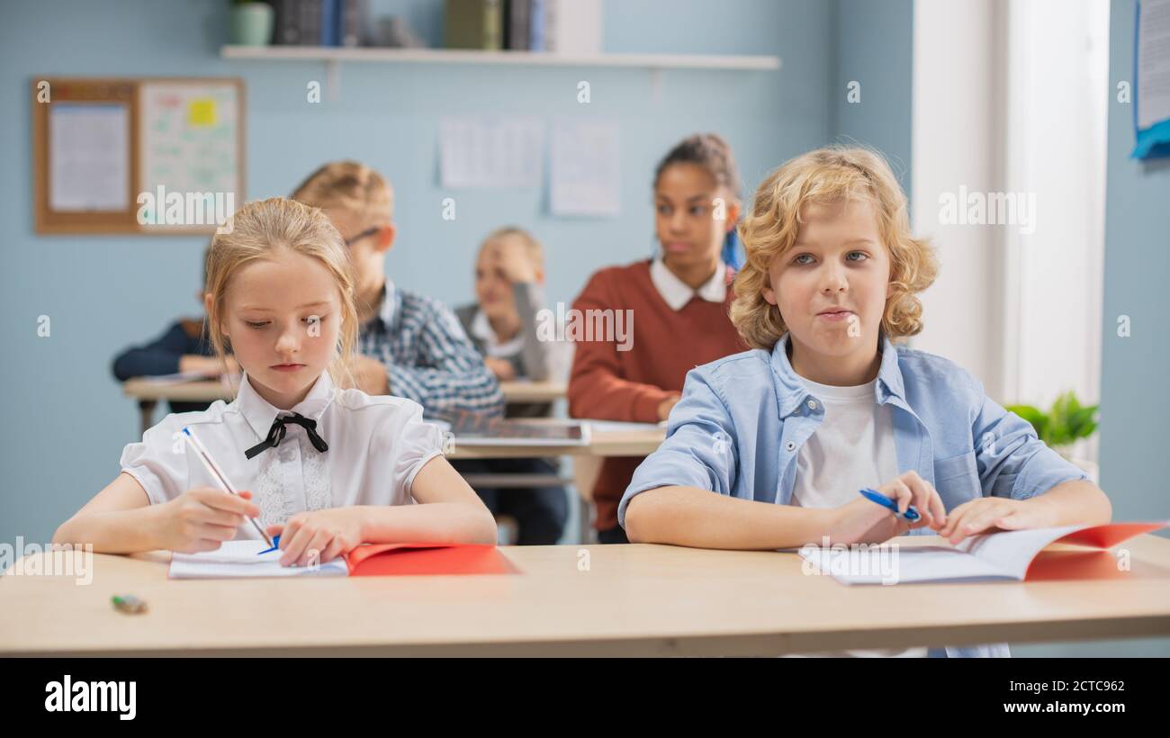 Elementary Classroom of Diverse Bright Children Listening Attentively ...