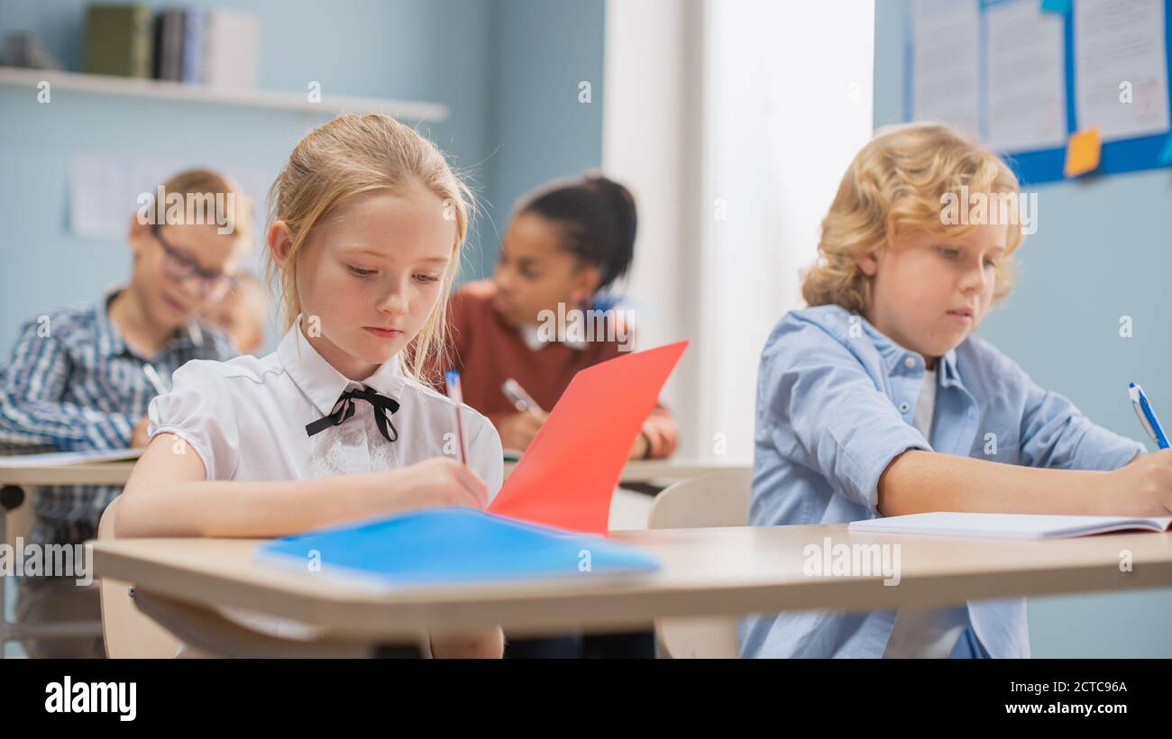 Elementary Classroom of Diverse Bright Children Listening Attentively ...