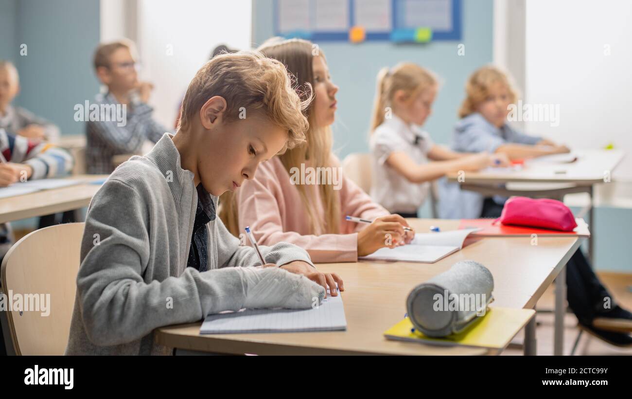 Elementary Classroom of Diverse Children Listening Attentively to their ...
