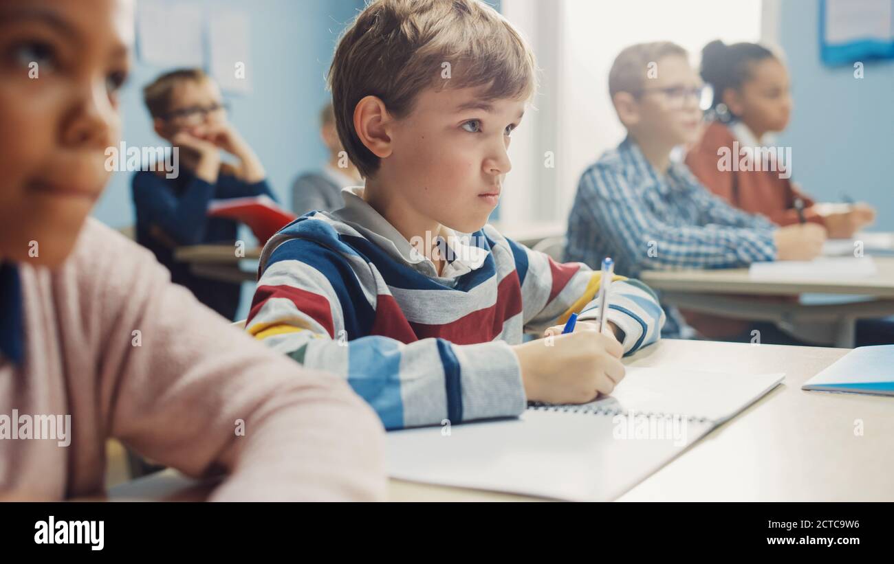In Elementary School Class: Portrait of Brilliant Caucasian Boy Writes ...