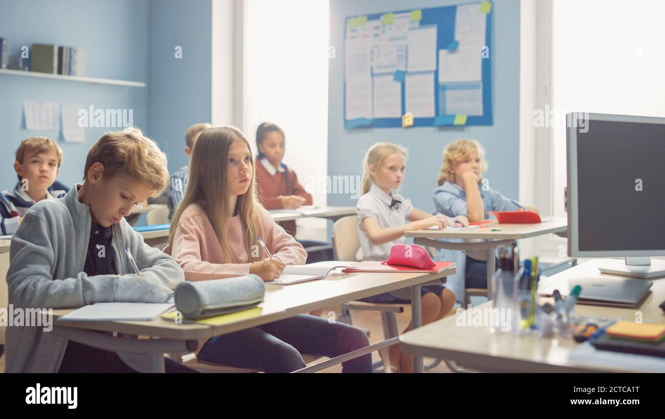 Elementary Classroom of Diverse Bright Children Listening Attentively ...