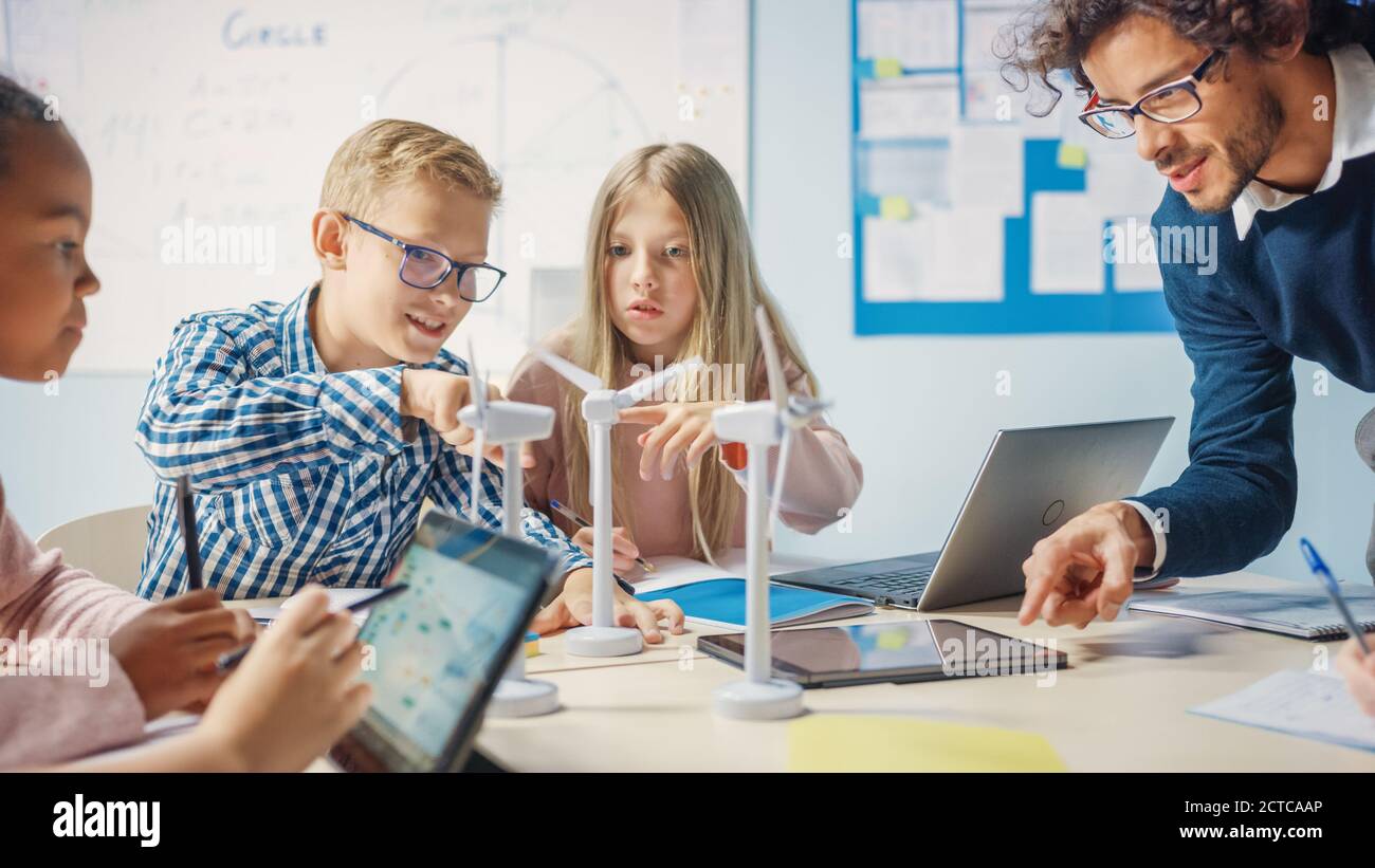 Elementary School Classroom: Enthusiastic Teacher Holding Tablet ...