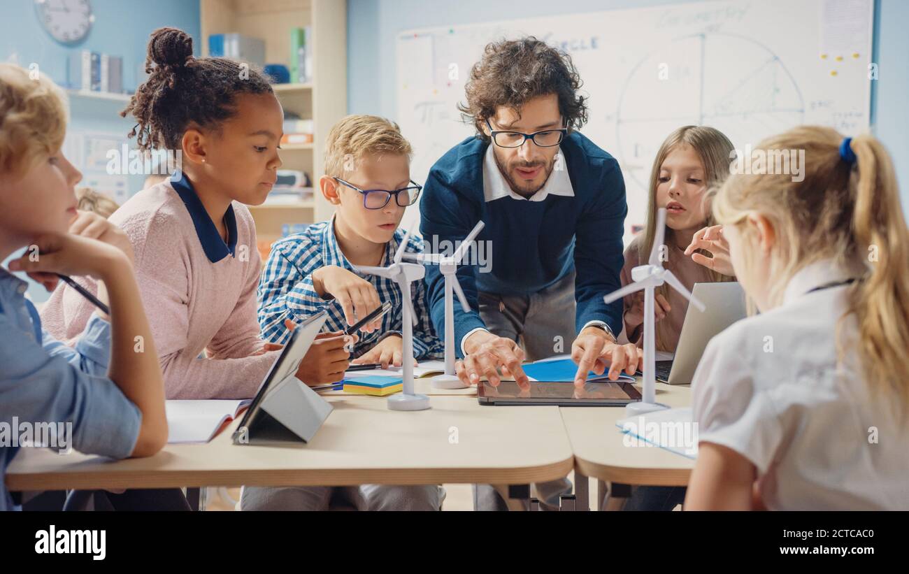 Elementary School Classroom: Enthusiastic Teacher Holding Tablet ...