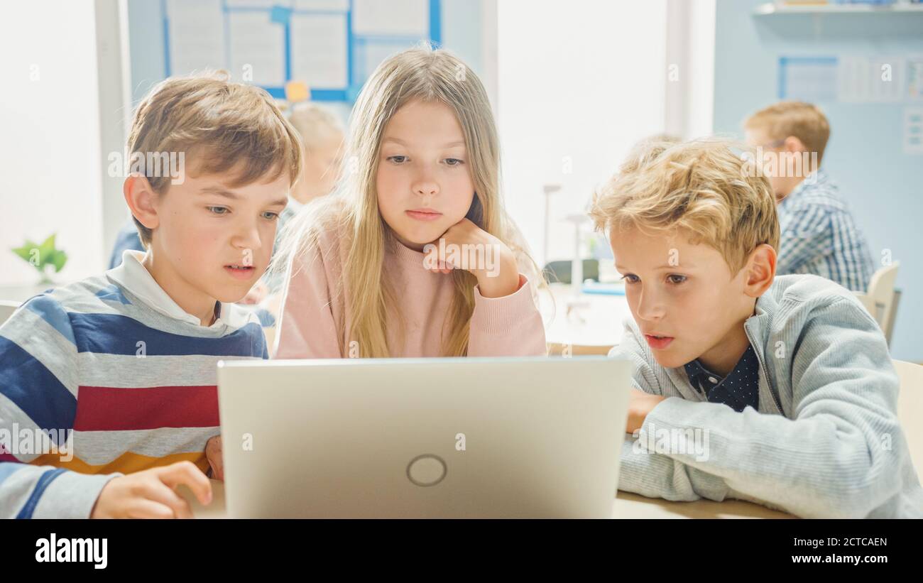 Elementary School Classroom: Diverse Group of Brilliant Children Using ...