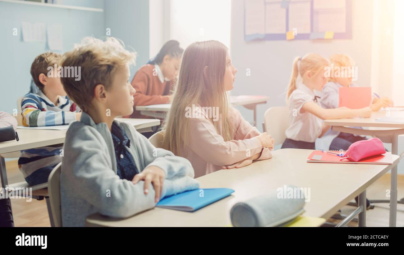 Elementary Classroom of Diverse Bright Children Listening Attentively ...