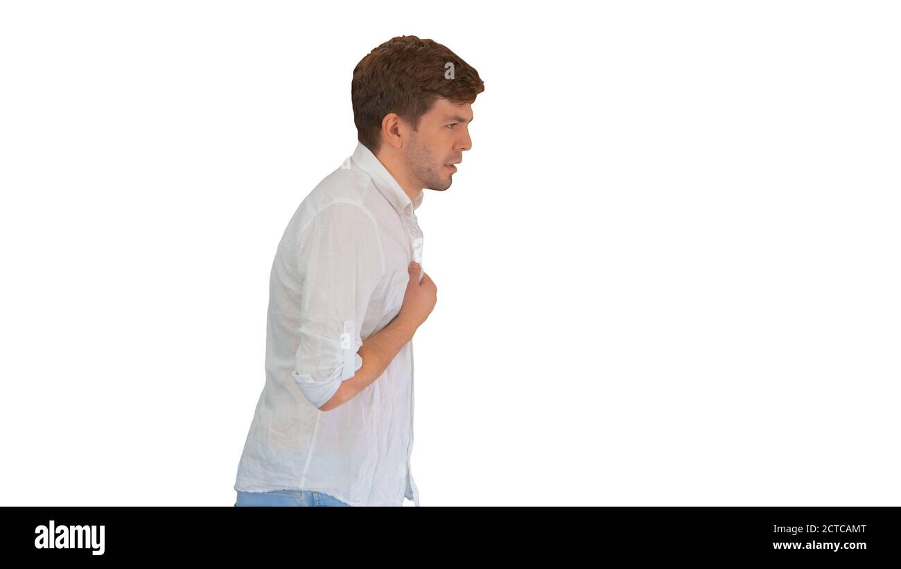 Exhausted young man suffering from heat while walking on white b Stock ...