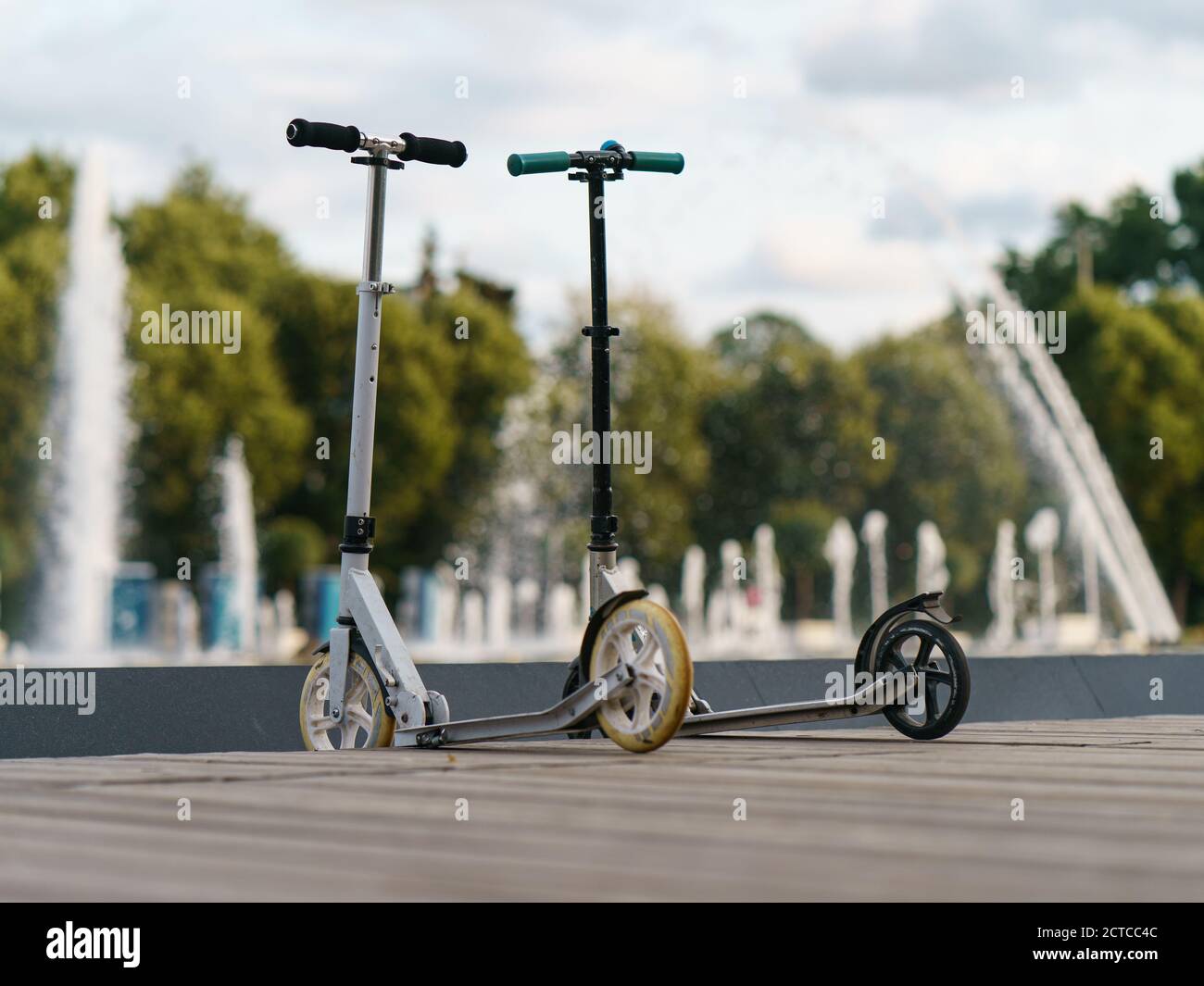 Photography of two parked push scooters near fountain in the public ...