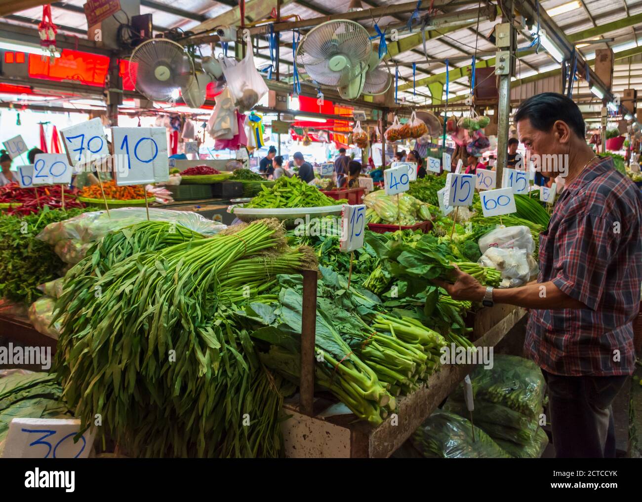 An array of fruits and vegetables on display at the Khlong Toei market ...