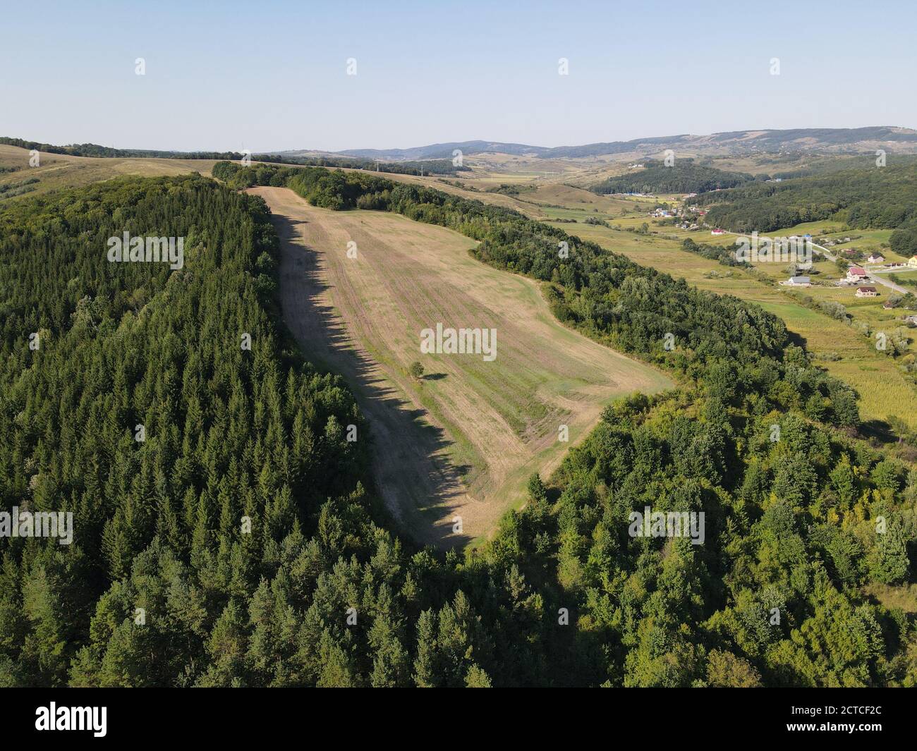 Aerial view of rural Romania, with houses, lakes, green forest and ...