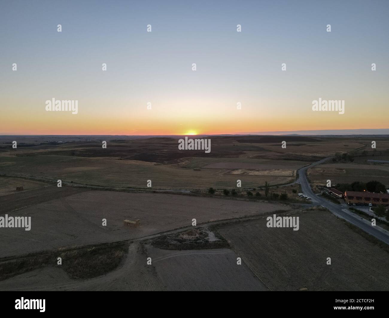 Aerial view of Segovia, Spain at sunset with the city and farmland ...