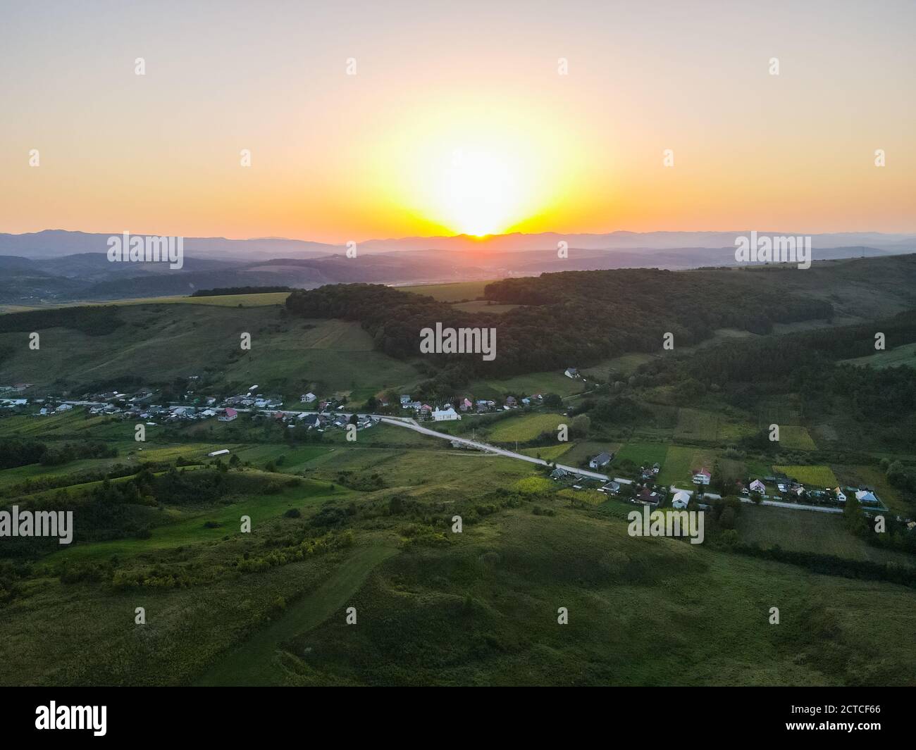 Aerial view of rural Romania, with houses, lakes, green forest and ...