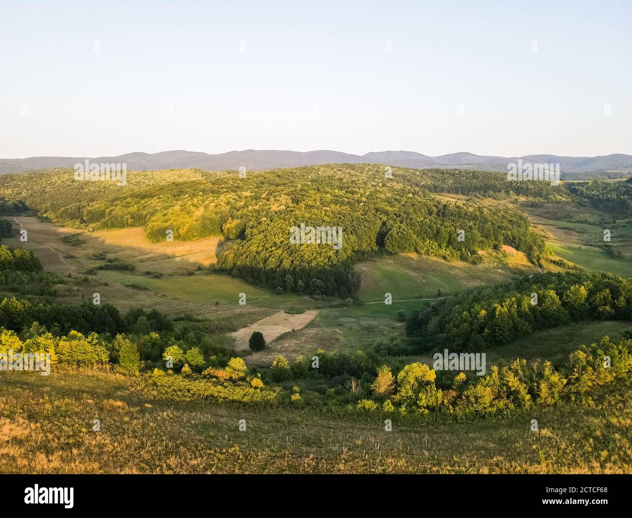 Aerial view of rural Romania, with houses, lakes, green forest and ...
