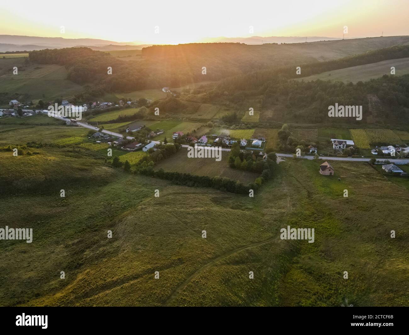 Aerial view of rural Romania, with houses, lakes, green forest and ...