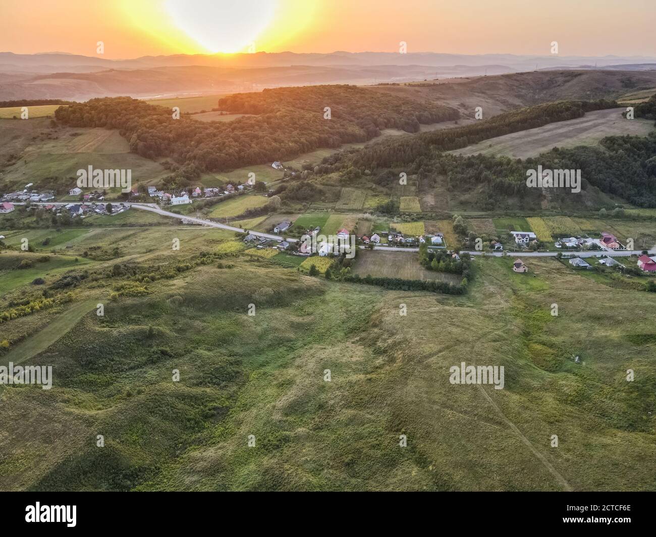 Aerial view of rural Romania, with houses, lakes, green forest and ...