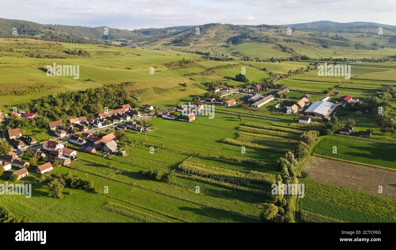 Aerial view of rural Romania, with houses, lakes, green forest and ...