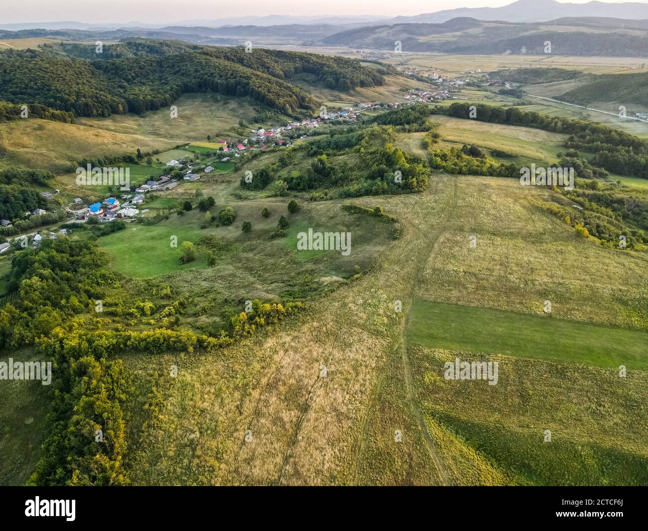 Aerial view of rural Romania, with houses, lakes, green forest and ...