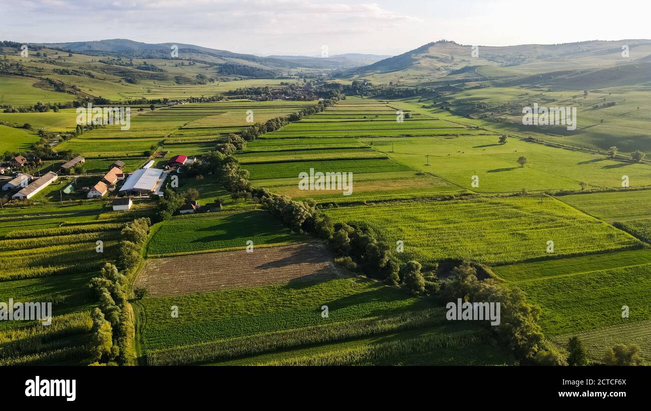 Aerial view of rural Romania, with houses, lakes, green forest and ...