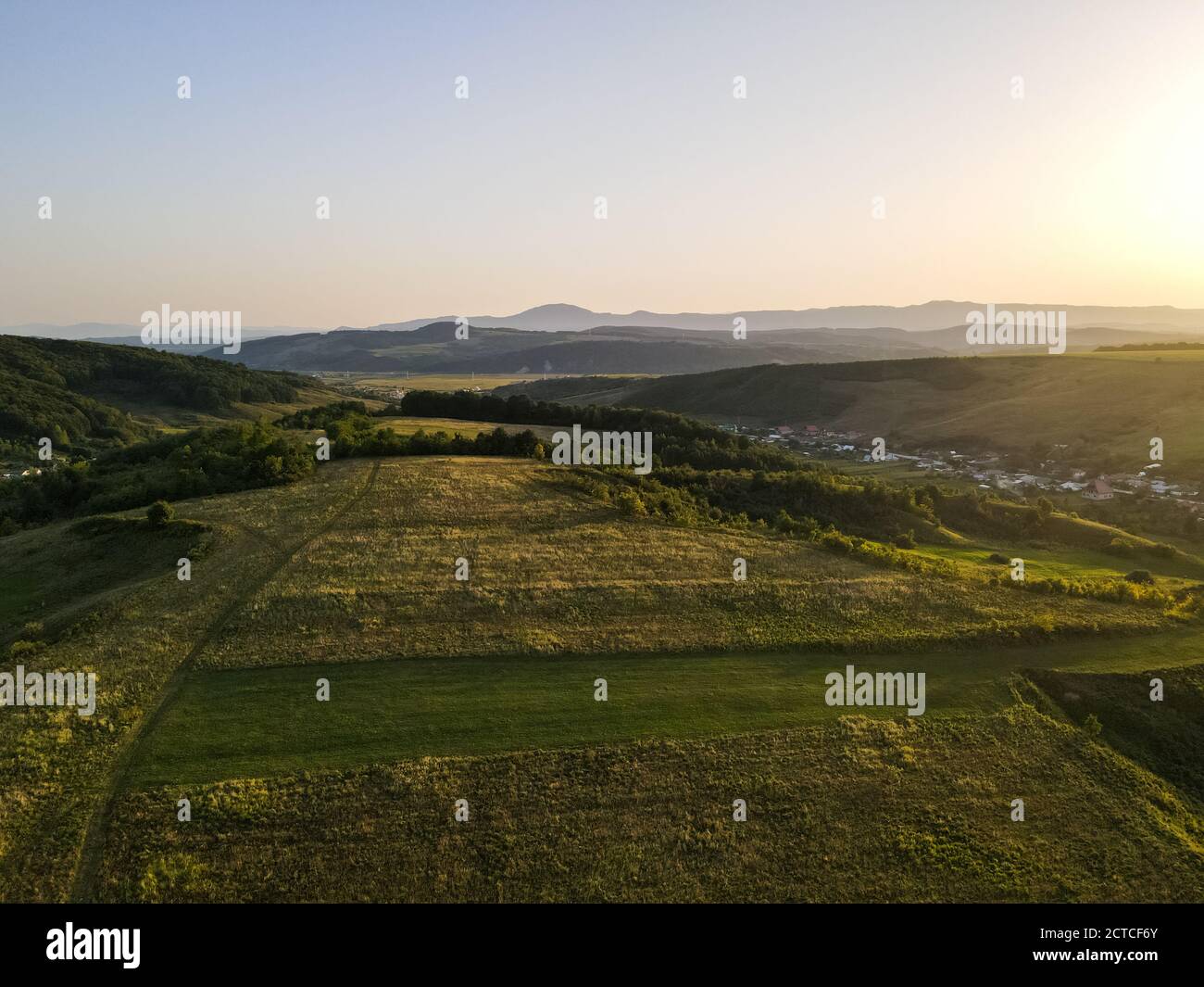 Aerial view of rural Romania, with houses, lakes, green forest and ...